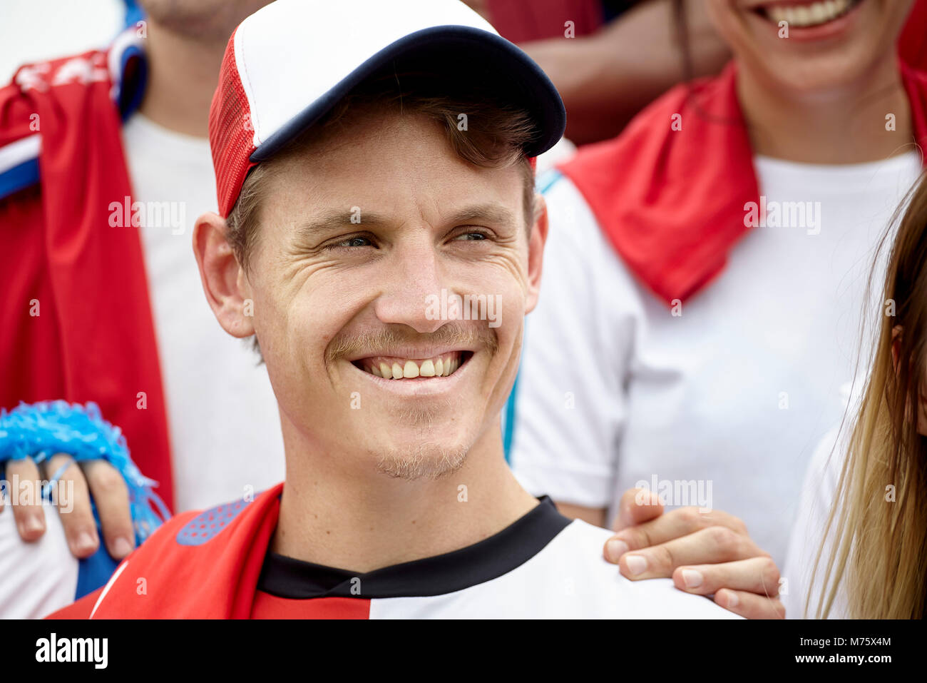 Football fan smiling at match, portrait Stock Photo - Alamy