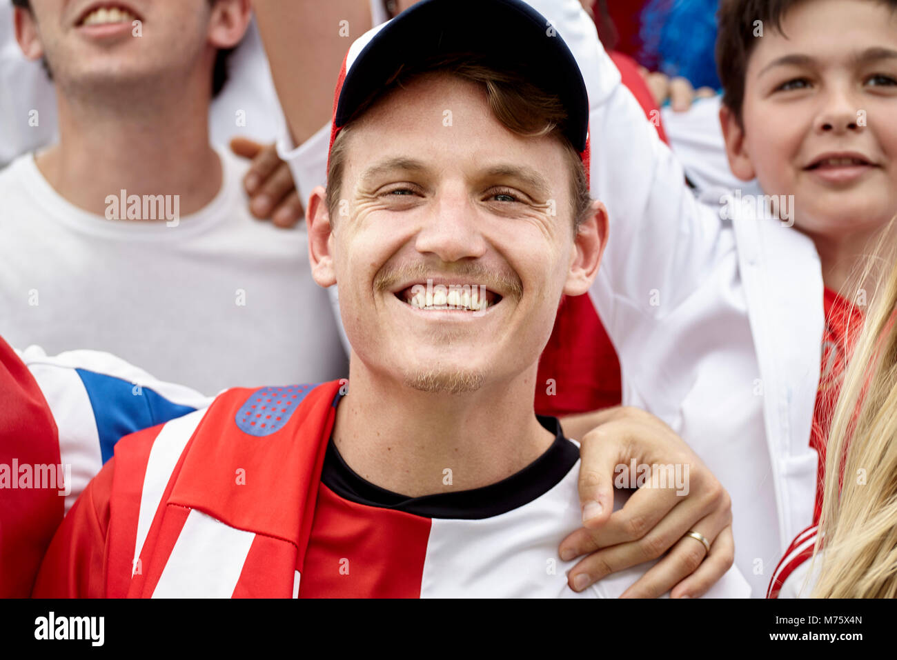 Football supporter smiling at match, portrait Stock Photo - Alamy