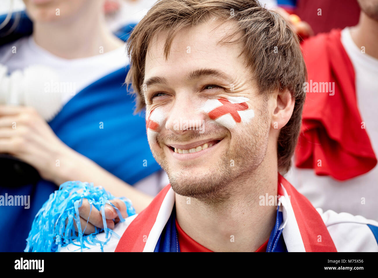 British football fan smiling cheerfully at match, portrait Stock Photo ...