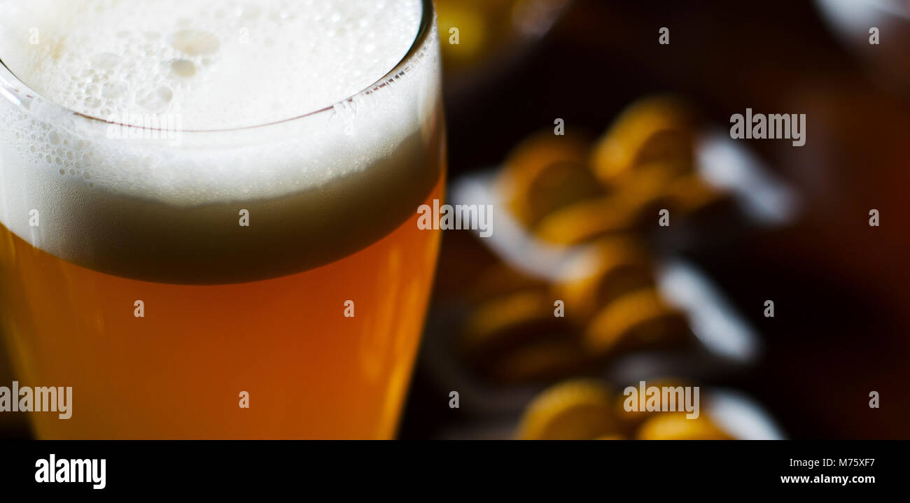 pint of lager beer in a glass, set of various snacks, a standard set of ...