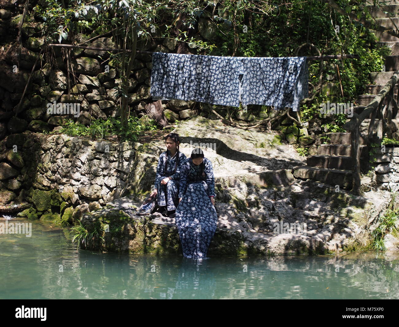 The Chinese Lady washing her clothes at the river at the local village ...