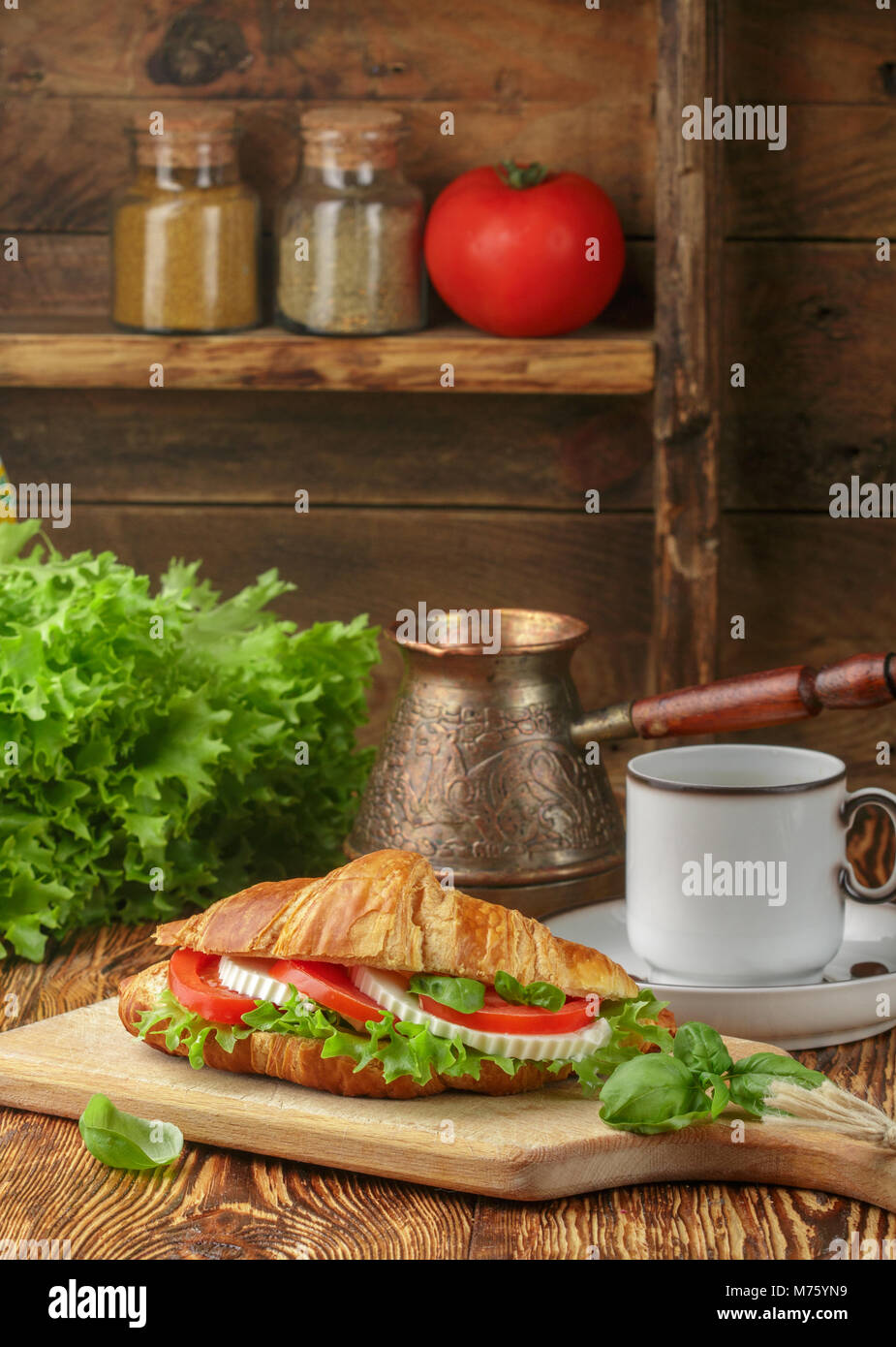 Traditional Breakfast. Croissant Sandwich with tomatoes, cheese ...