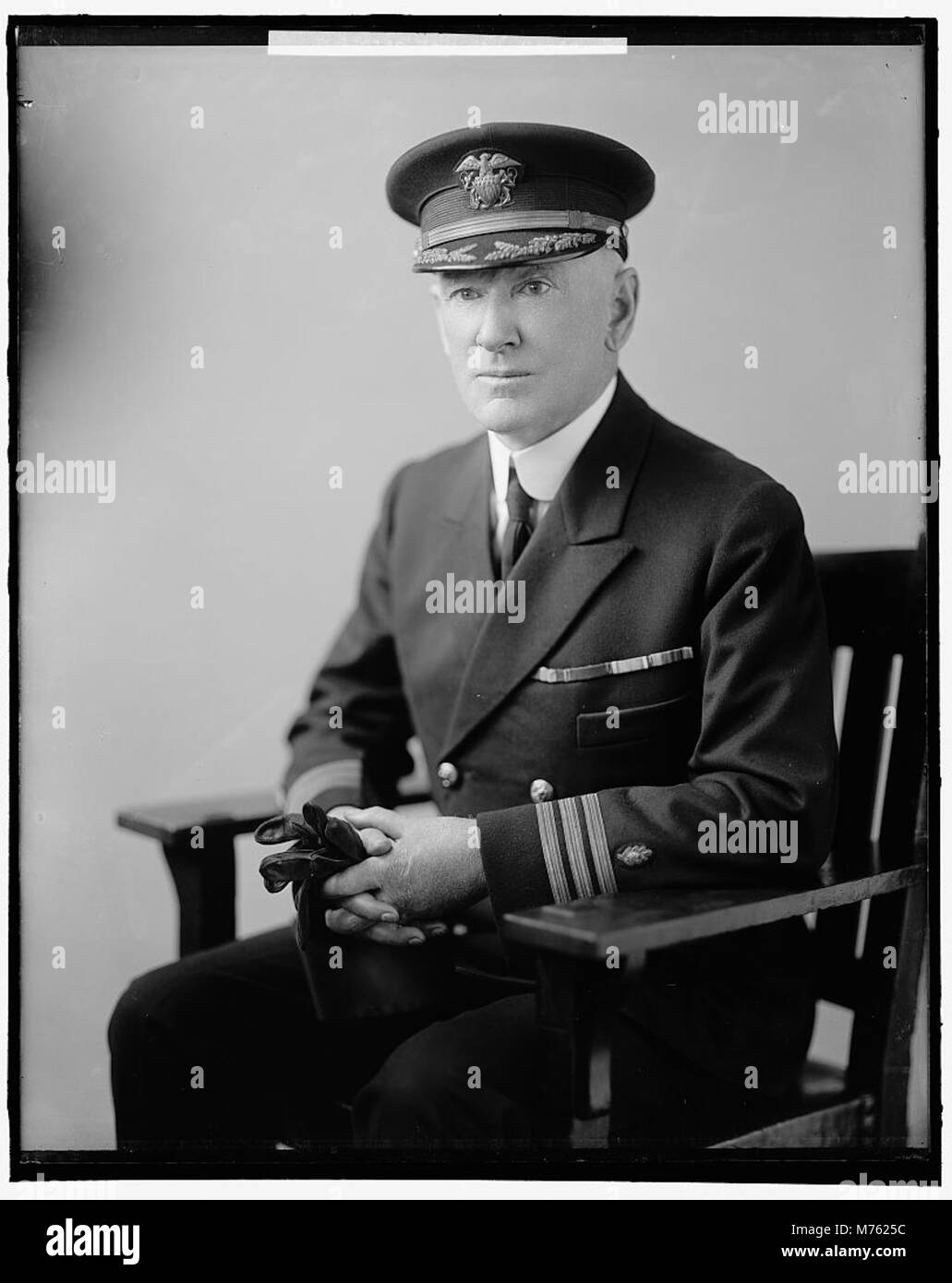 A portrait of J. Kennedy, Commander, captured in a formal setting ...