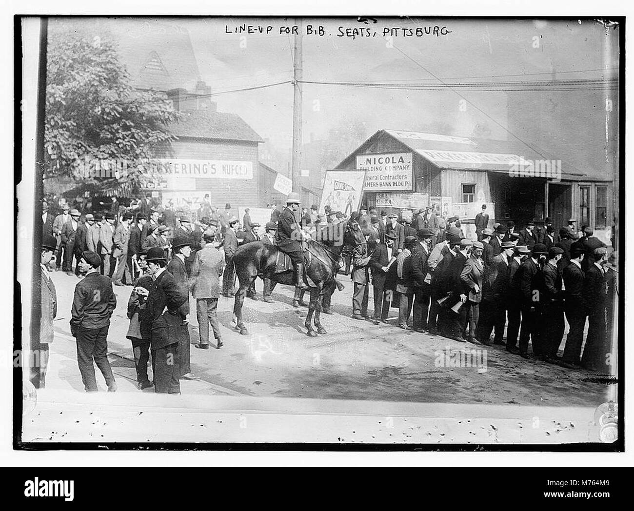 A historical photograph from 1912 showing a crowd waiting in line for ...