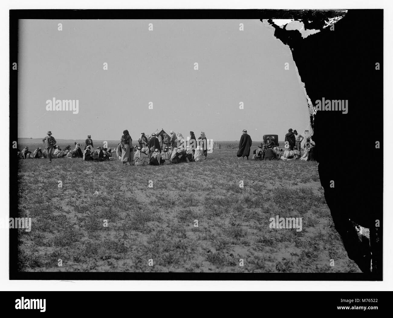 A historical photograph depicting workers, known as locust killers, in ...