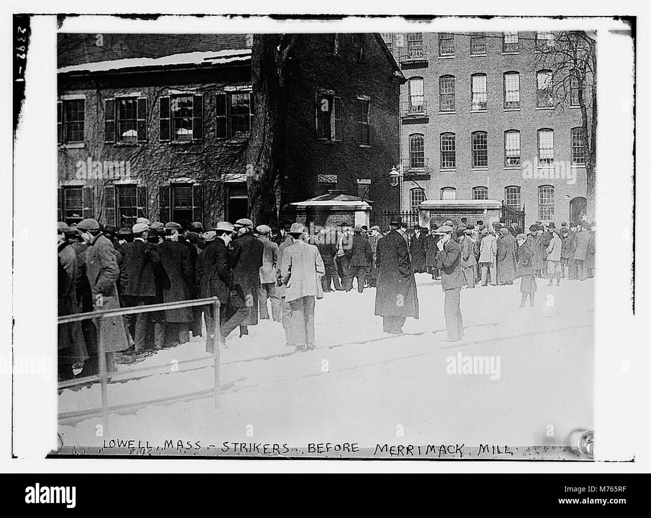 A historical photograph of workers on strike in front of the Merrimack ...