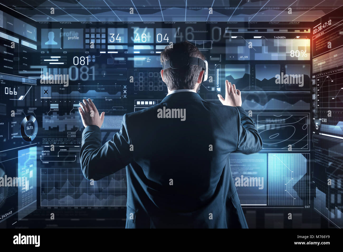 Young programmer putting his hands up while being in virtual reality ...