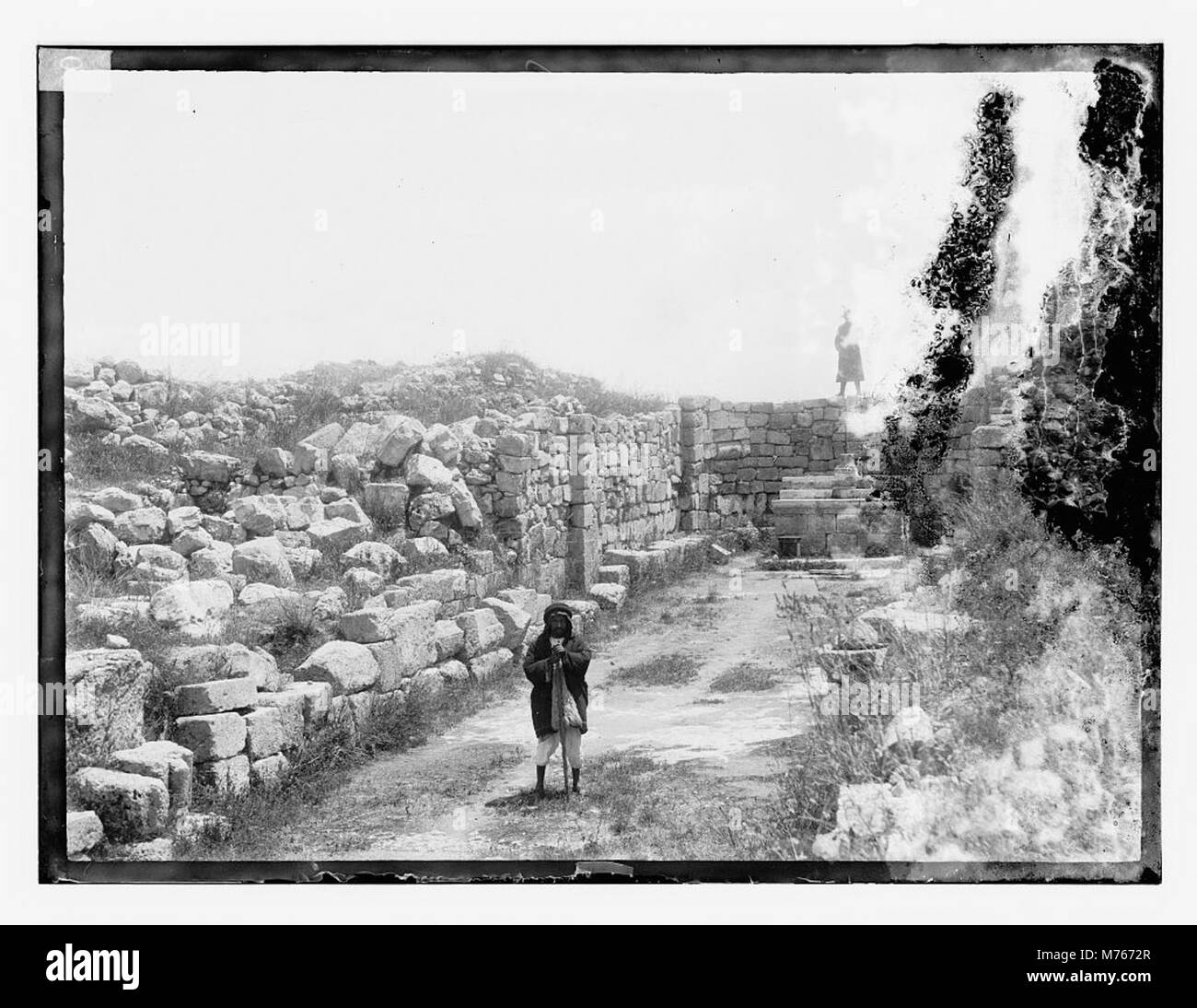A man is depicted standing among the ruins, possibly after a disaster ...