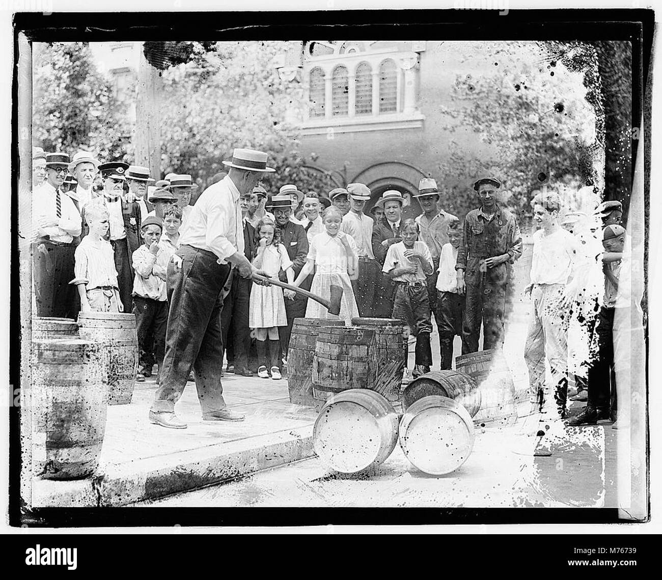 A man is seen breaking barrels with an ax on the sidewalk on July 8 ...