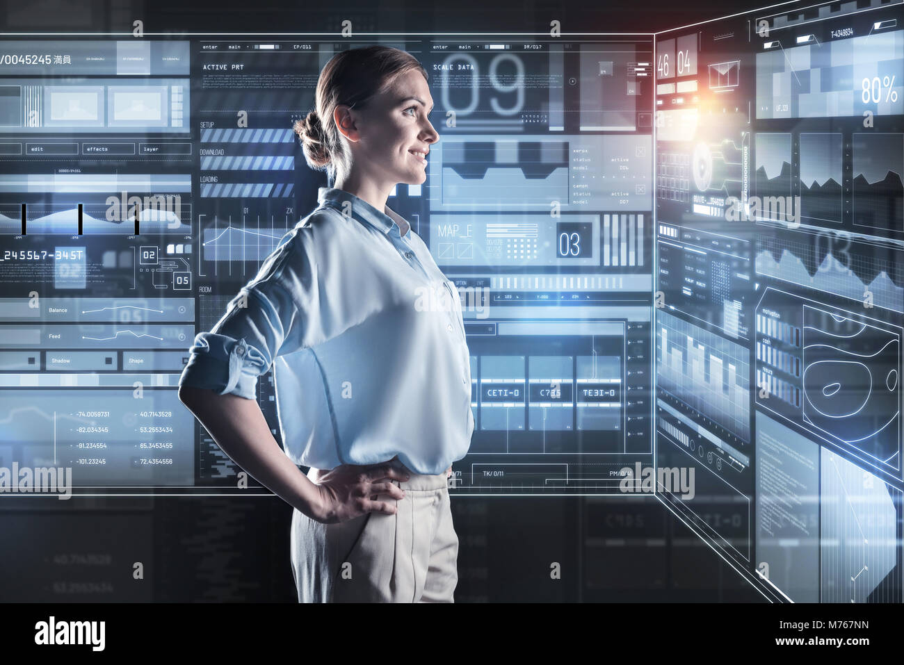 Satisfied programmer smiling at looking at her computer Stock Photo - Alamy