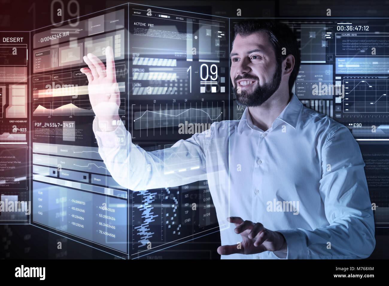 Positive programmer feeling impressed while looking at the screen Stock Photo - Alamy