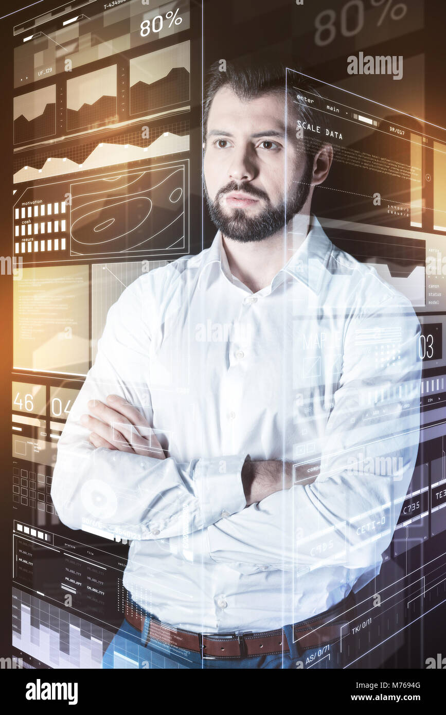 Serious programmer standing with his arms crossed and thinking Stock ...