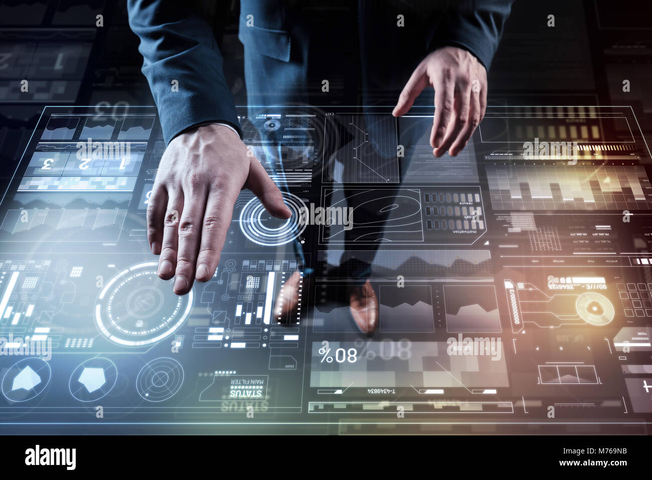 Elegant young man touching an amazing screen while working Stock Photo ...