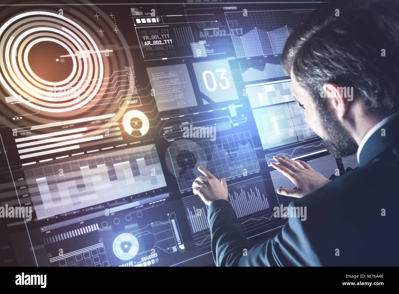 Bearded young programmer touching the transparent screen and thinking ...