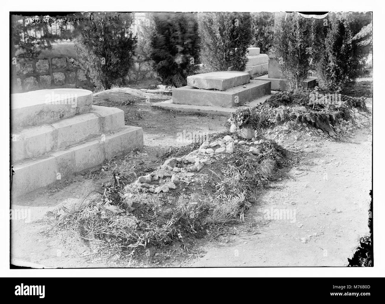 This photograph shows the grave of Mr. Jamal, located in a cemetery ...