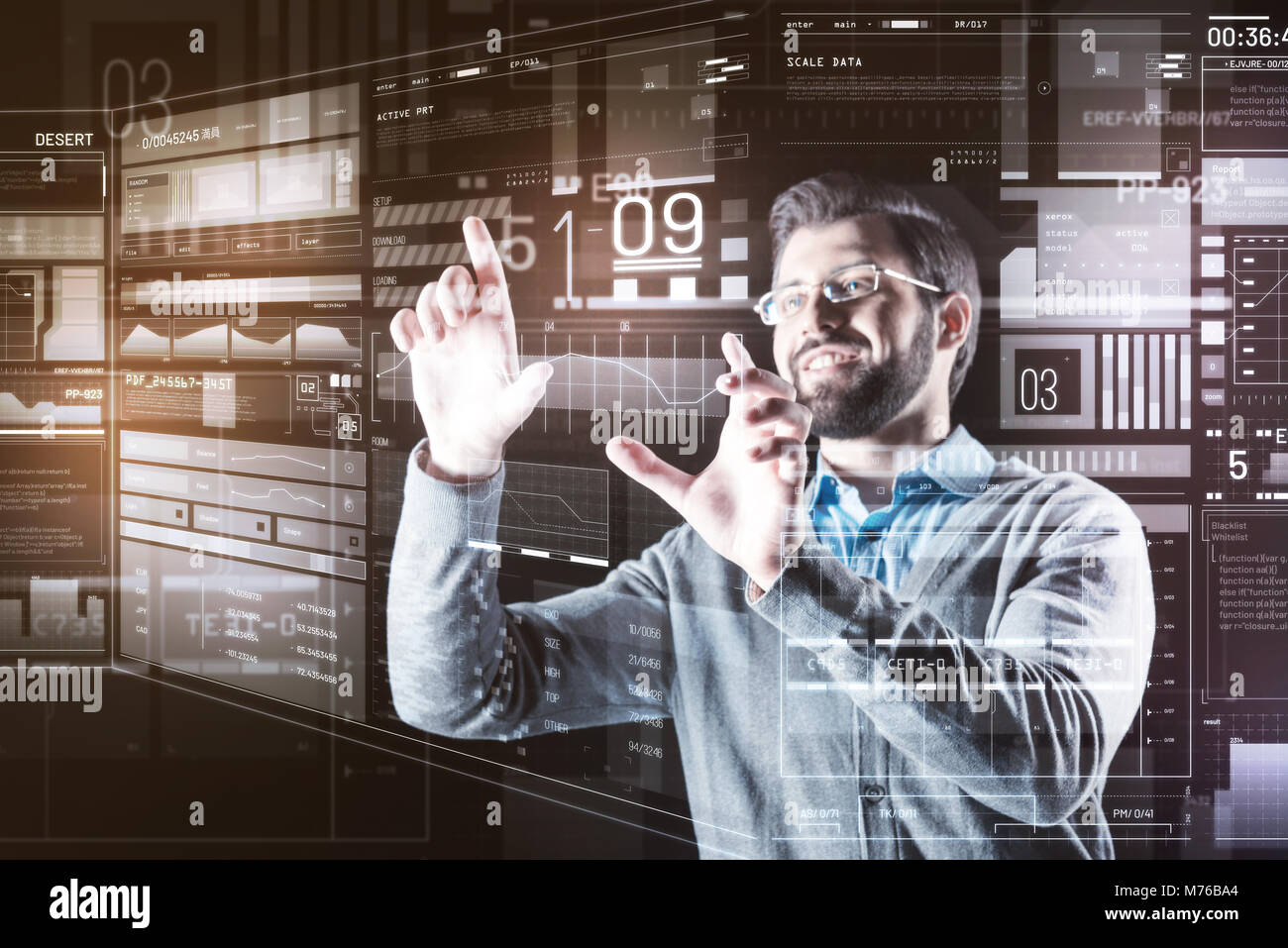 Happy programmer touching the screen and smiling while working Stock Photo - Alamy