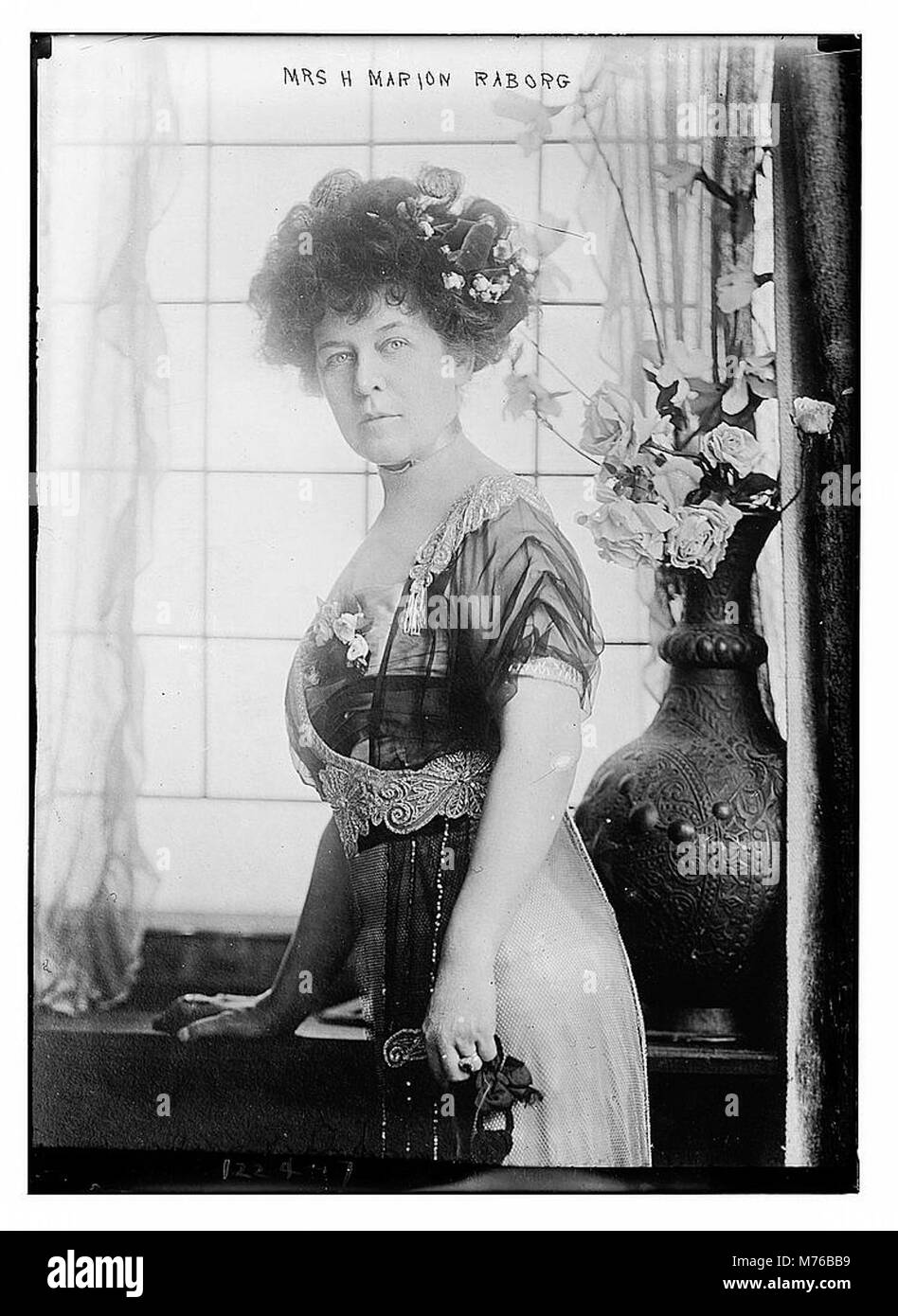 A formal portrait of Mrs. H. Marion Raborg, capturing her elegance and ...