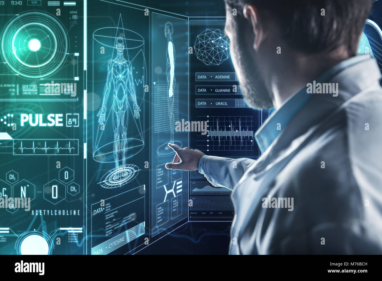Clever doctor pointing to the screen while working with modern ...