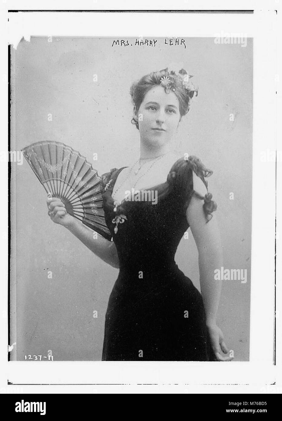 This portrait depicts Mrs. Harry Lehr, a figure known for her social ...