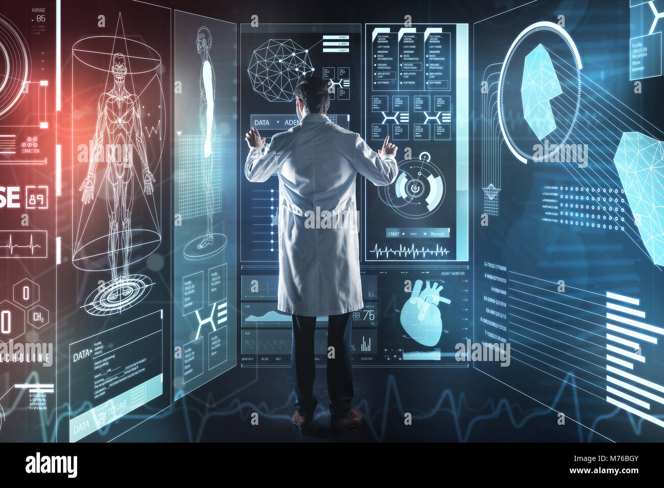 Calm medical worker feeling concentrated while touching the transparent ...