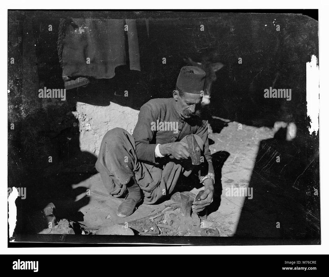 An image showing a native blacksmith in the process of making ...