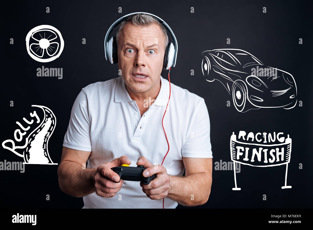 Emotional man feeling interested while playing video games Stock Photo ...