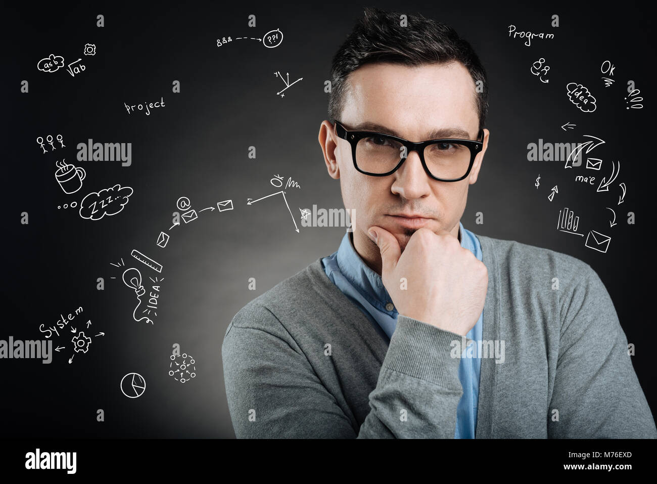 Clever young scientist touching his chin while thinking Stock Photo - Alamy