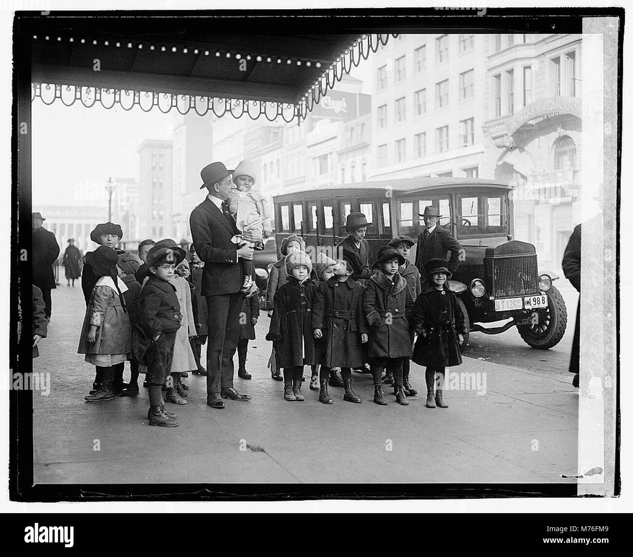 This image shows a group of orphans at Loews Palace, likely part of a ...