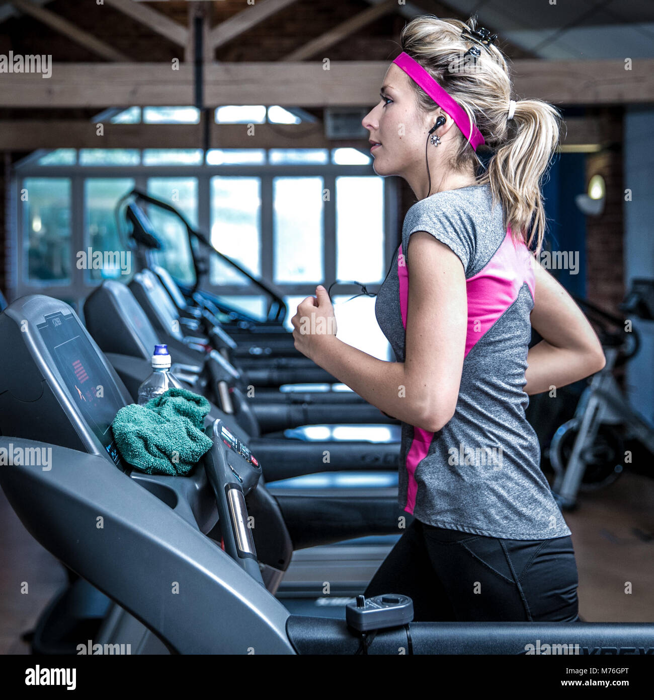 Girl on a treadmill working out in the gym Stock Photo - Alamy