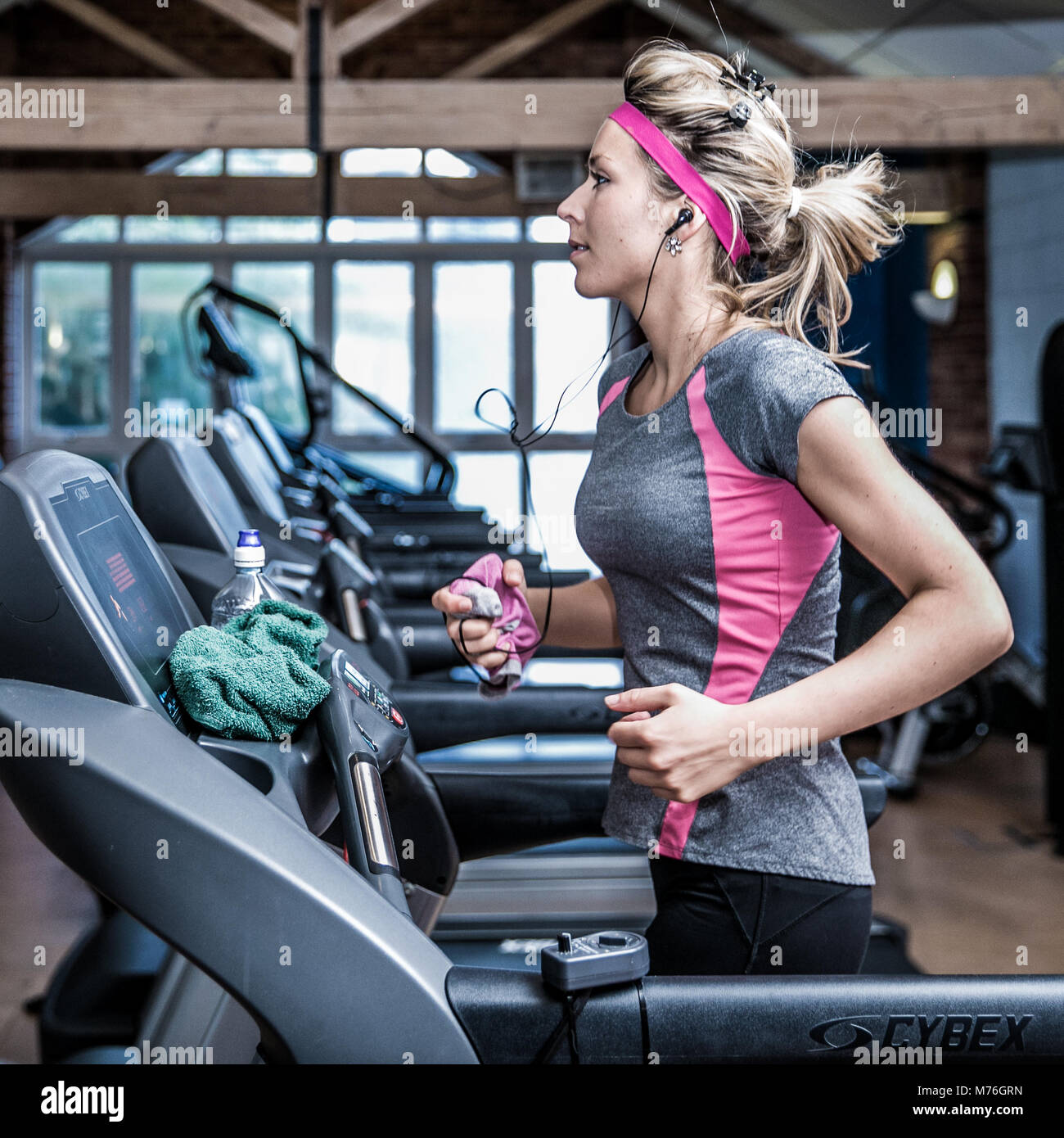 Girl on a treadmill working out in the gym Stock Photo - Alamy