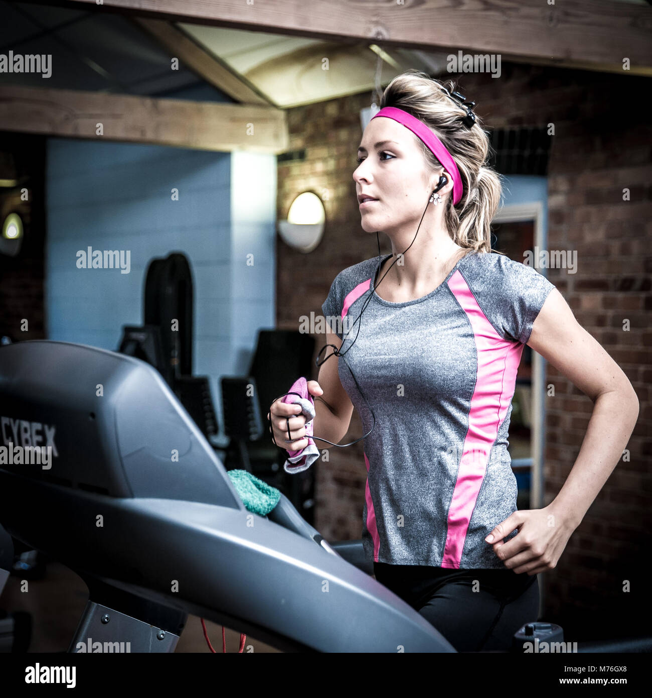 Girl on a treadmill working out in the gym Stock Photo - Alamy