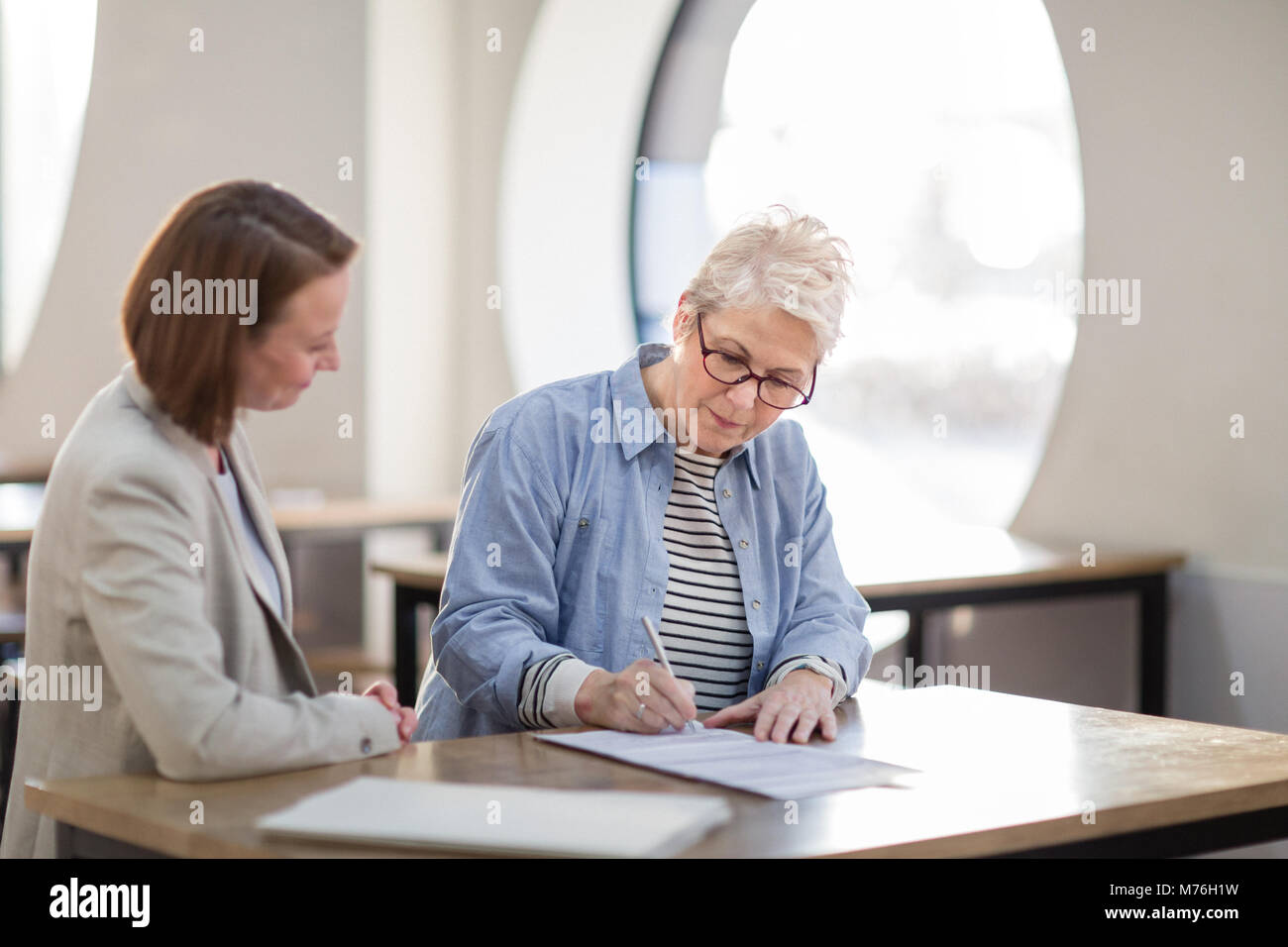 Senior woman with personal finance advisor Stock Photo - Alamy