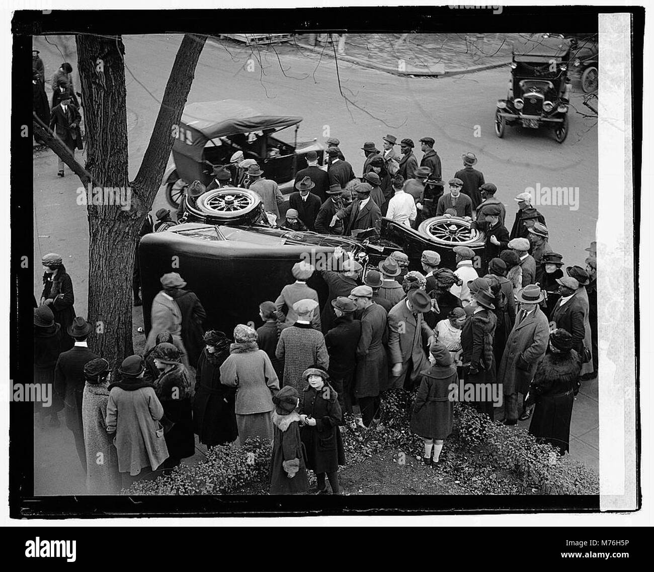 A photograph of a car wreck, depicting a traffic accident scene. The ...
