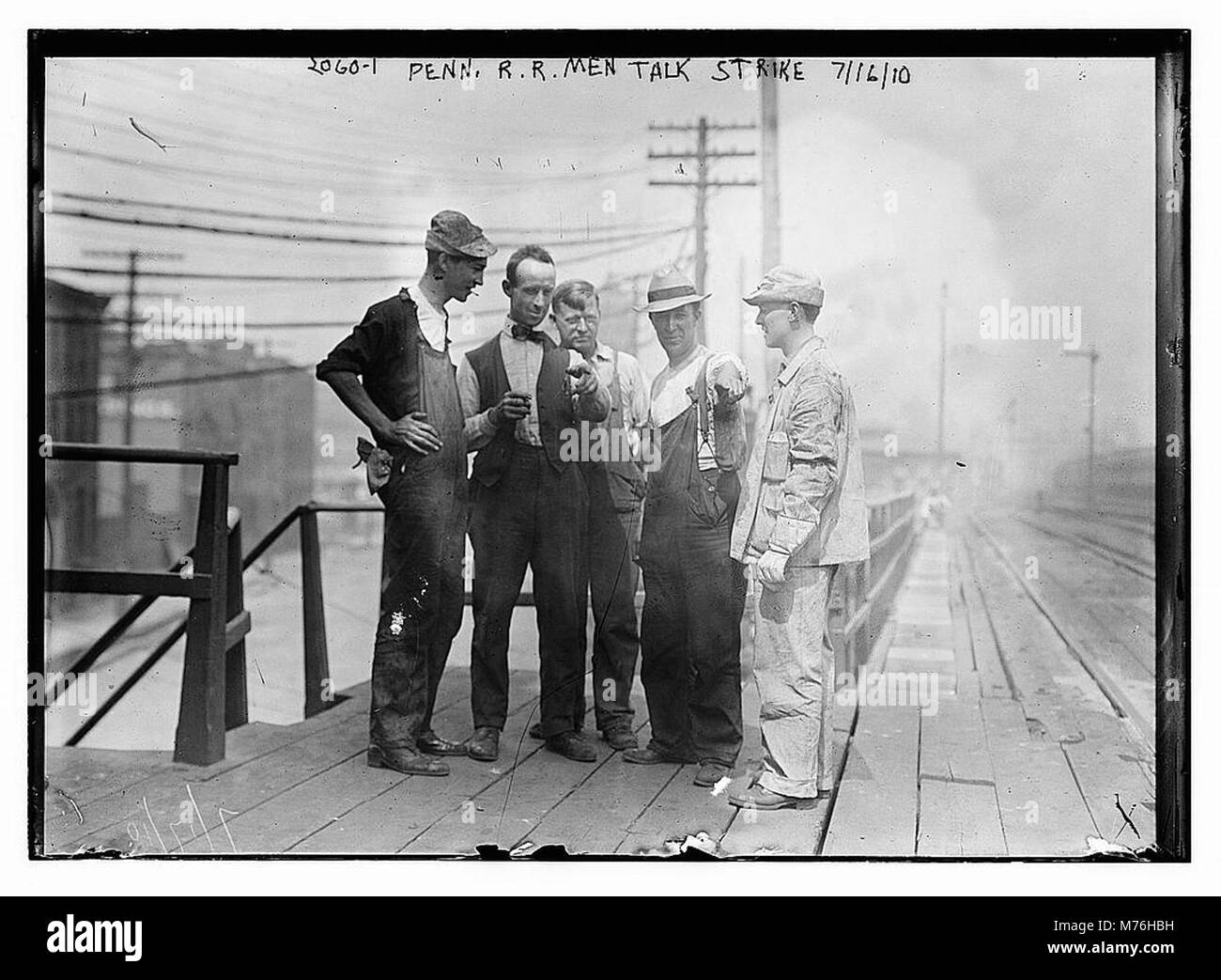 A photograph showing workers of the Pennsylvania Railroad discussing a ...