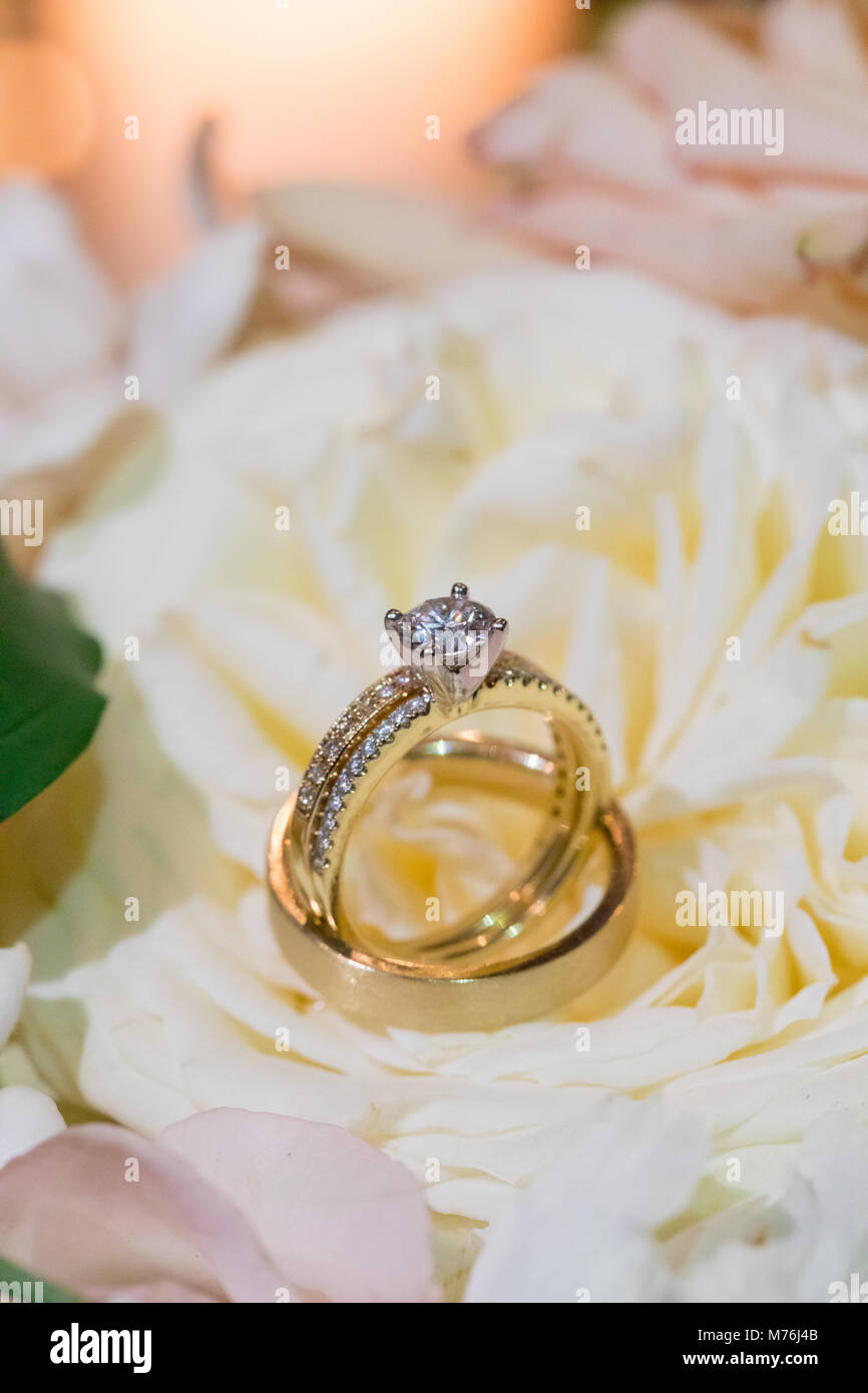 Wedding Rings on Flowers Stock Photo - Alamy