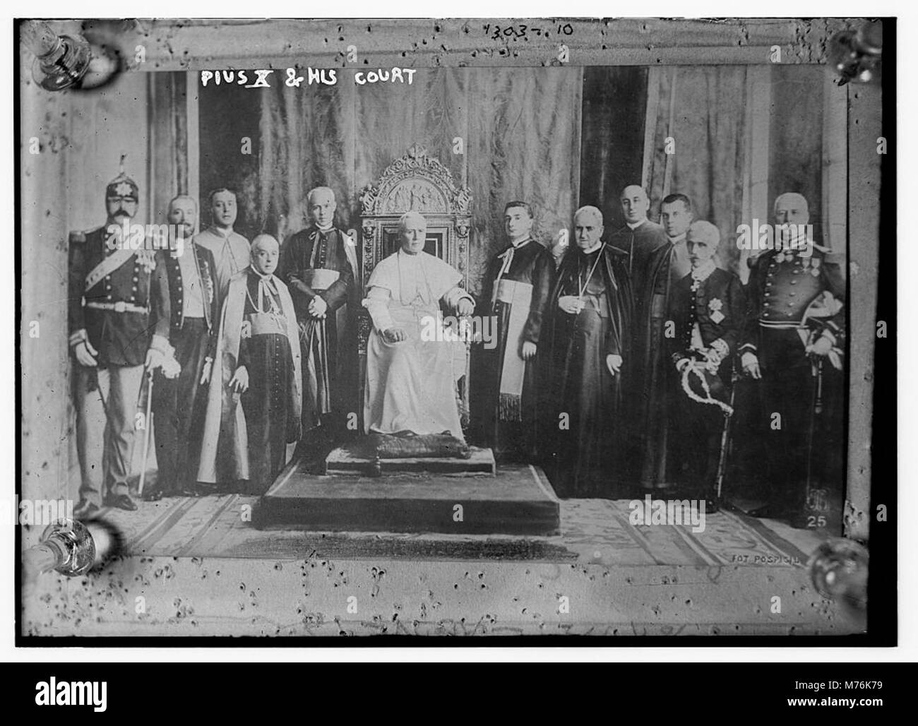 Pope Pius X and his court are featured in this photograph, depicting ...