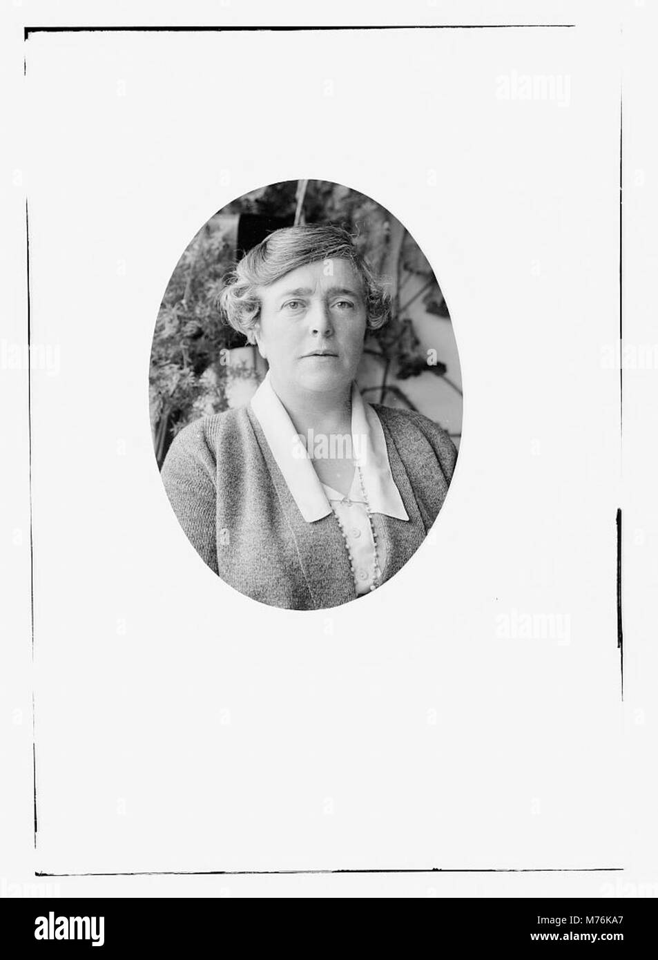 This portrait features a woman depicted within an oval frame, a typical ...