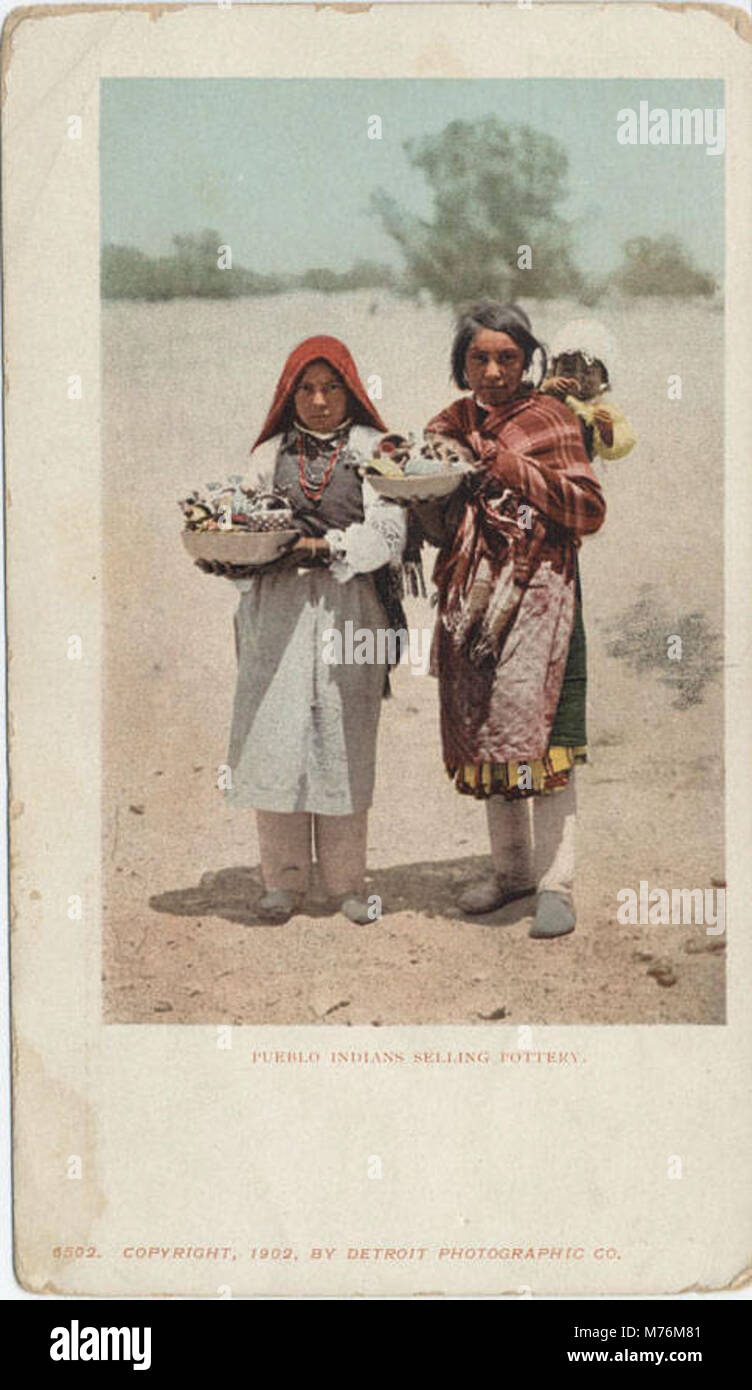 A photograph showing Pueblo Indians selling traditional pottery ...