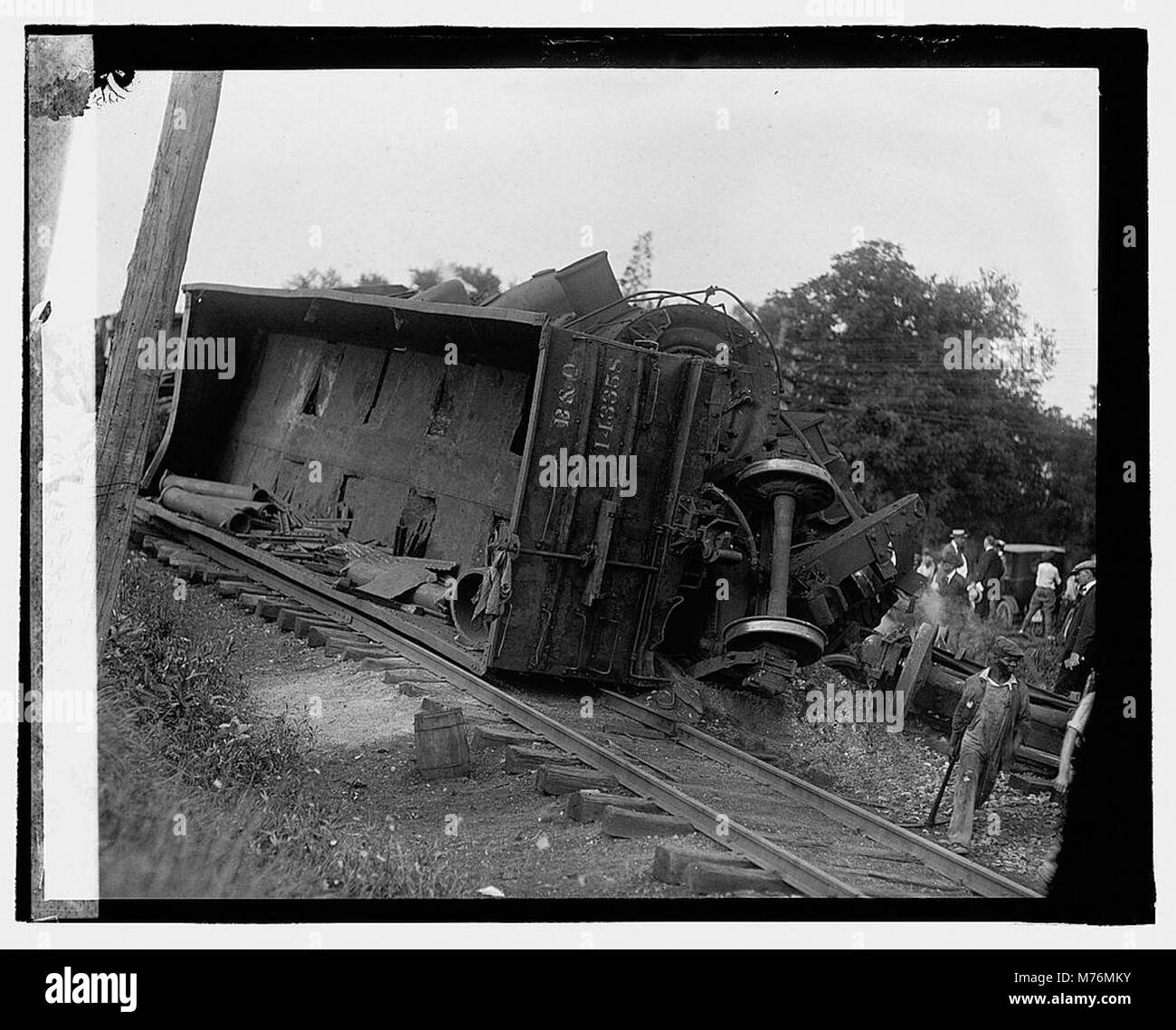 This image depicts the aftermath of a railroad wreck, showcasing the ...