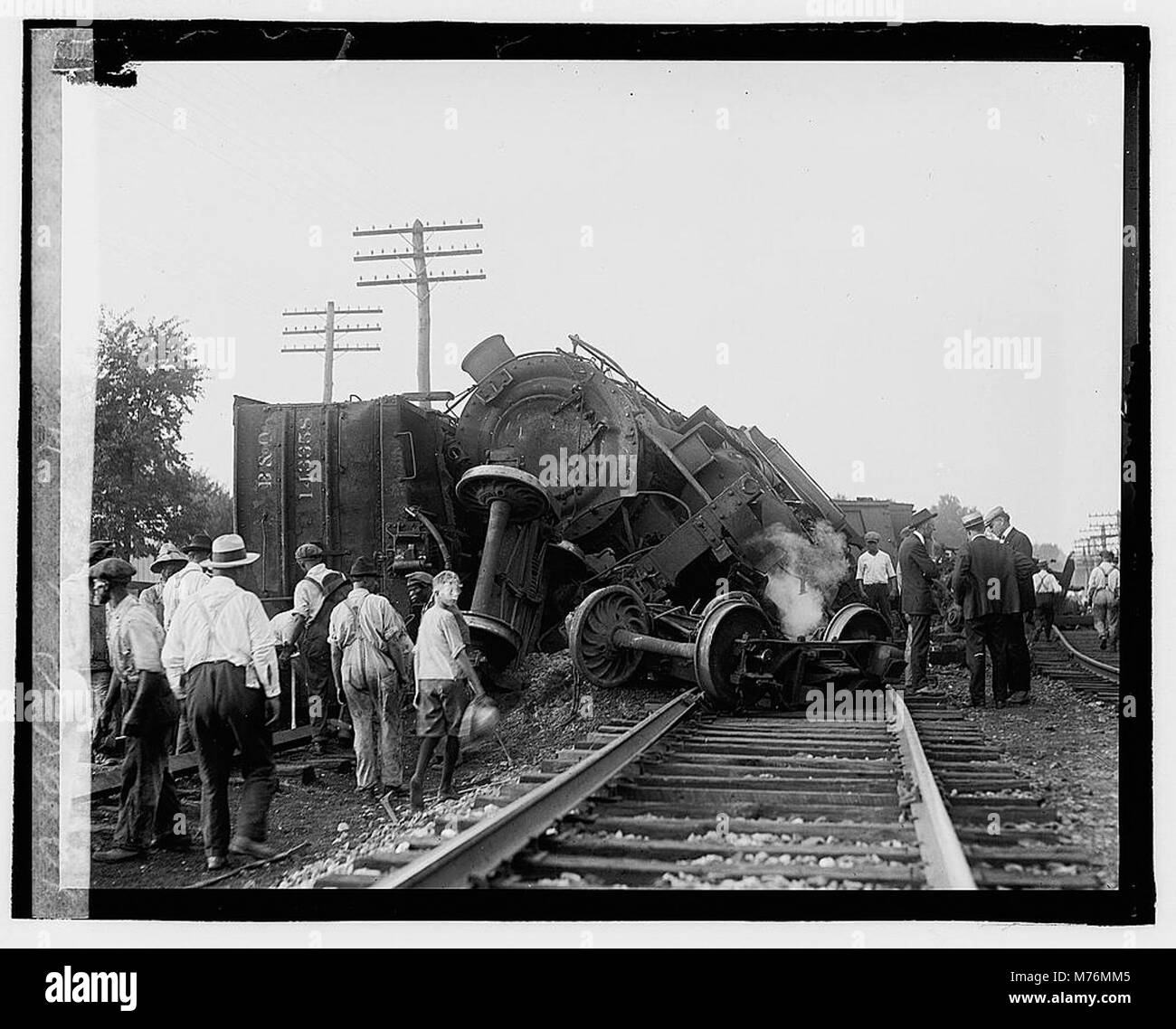 A photograph depicting a railroad wreck, capturing the aftermath of a ...