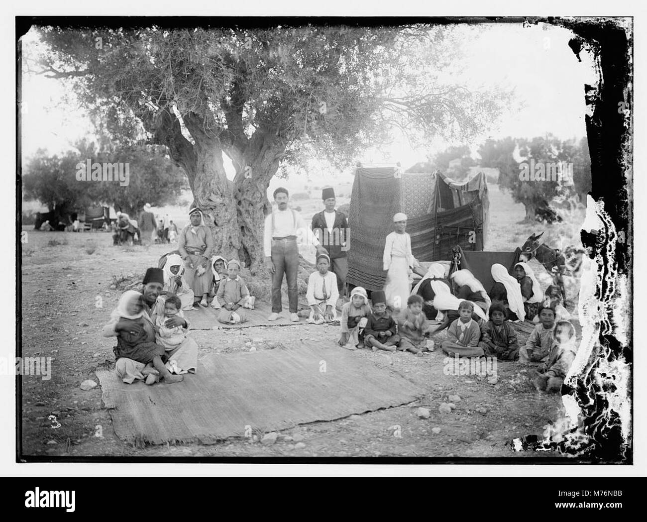 A photograph of refugees, capturing a moment of displacement. This ...