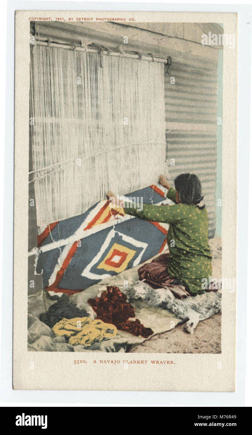 A Navajo blanket weaver is shown in traditional attire, demonstrating ...