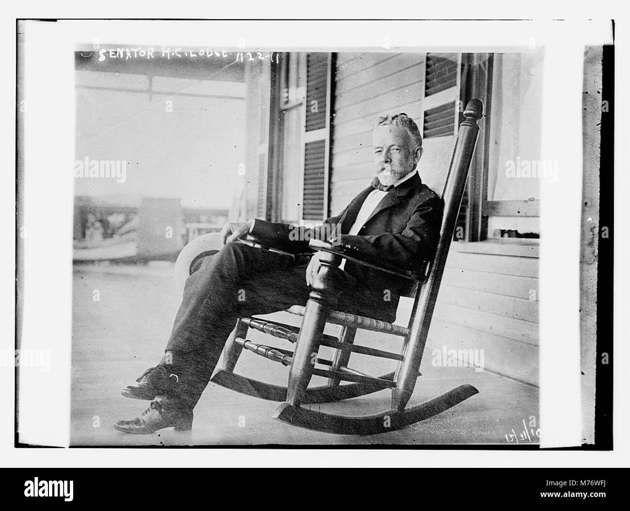 A photograph of Senator Henry Cabot Lodge sitting in a rocking chair on ...