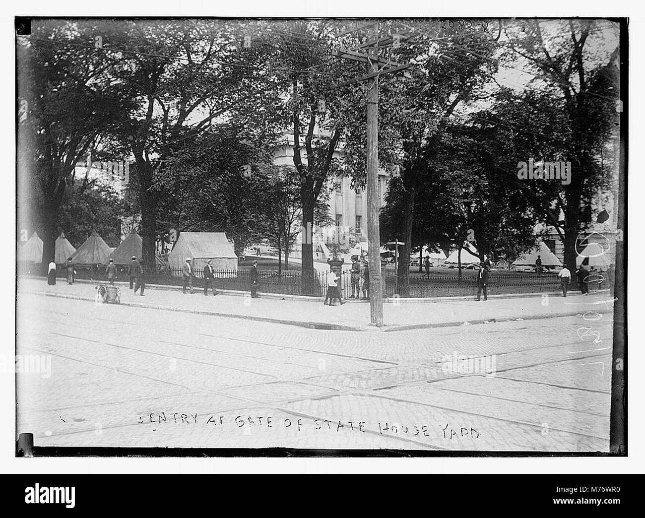 A photograph of a sentry standing guard at the gate of the State House ...