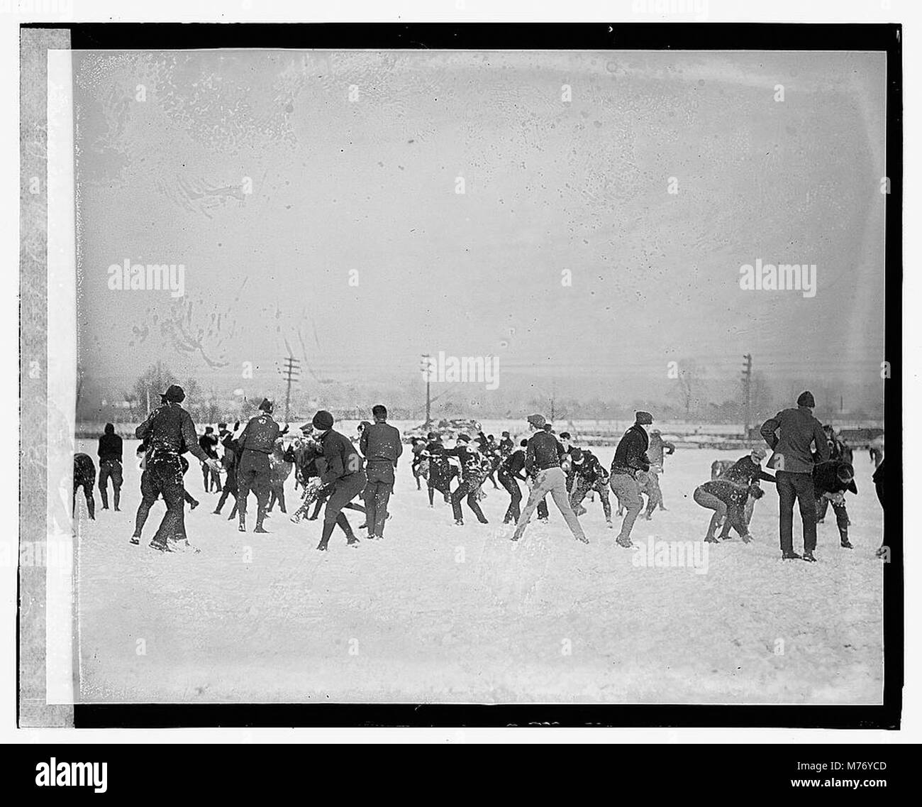 A group of people participating in a snowball fight at College Park ...