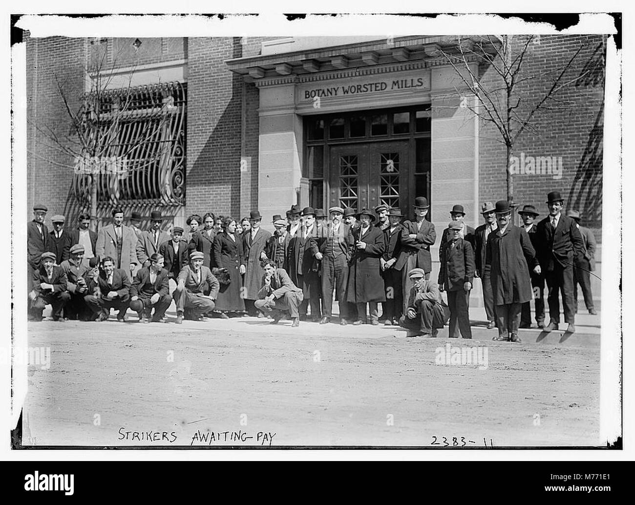 A photograph capturing workers on strike, waiting for their pay during ...