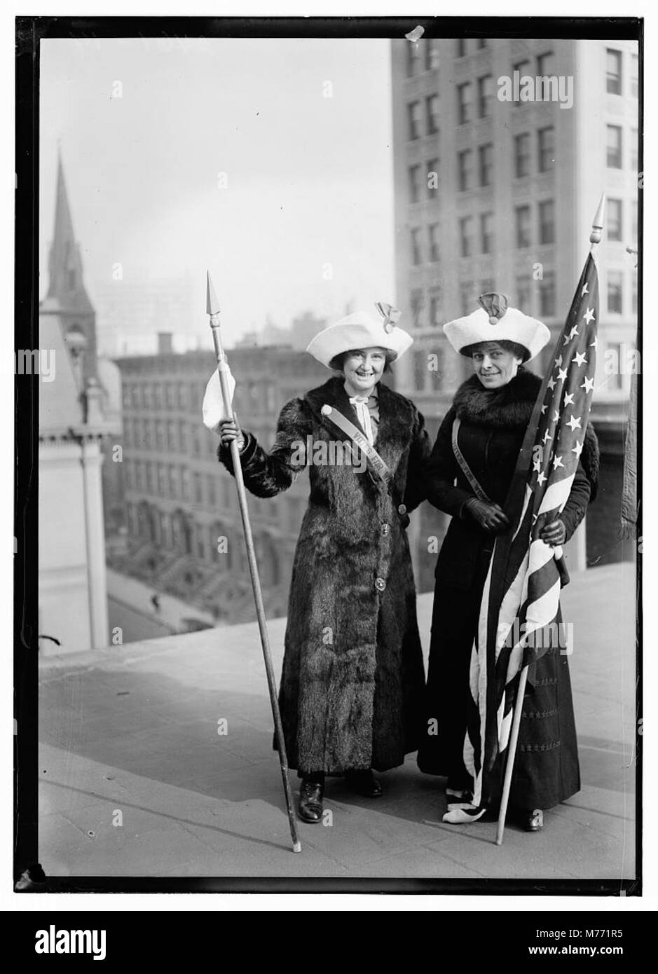 A photograph of suffragettes holding a flag, likely taken during a ...