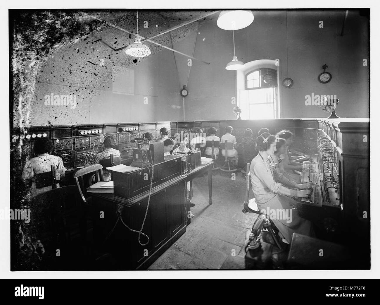 A photograph of a telephone company switchboard, showcasing early ...