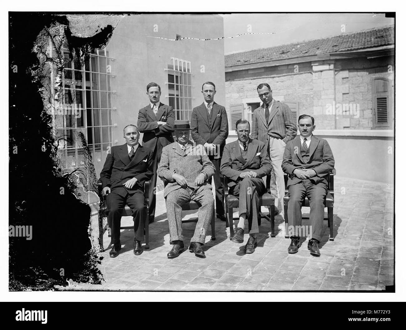 A historical photograph showing a bank staff consisting of seven men ...