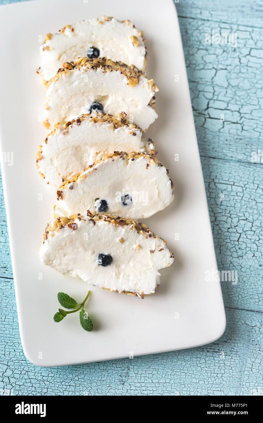 Sliced merengue roll with nuts Stock Photo - Alamy